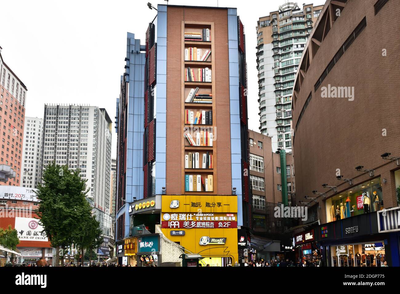 A bookshelf with huge books which are 2 meters high and 1.5 meters wide ...
