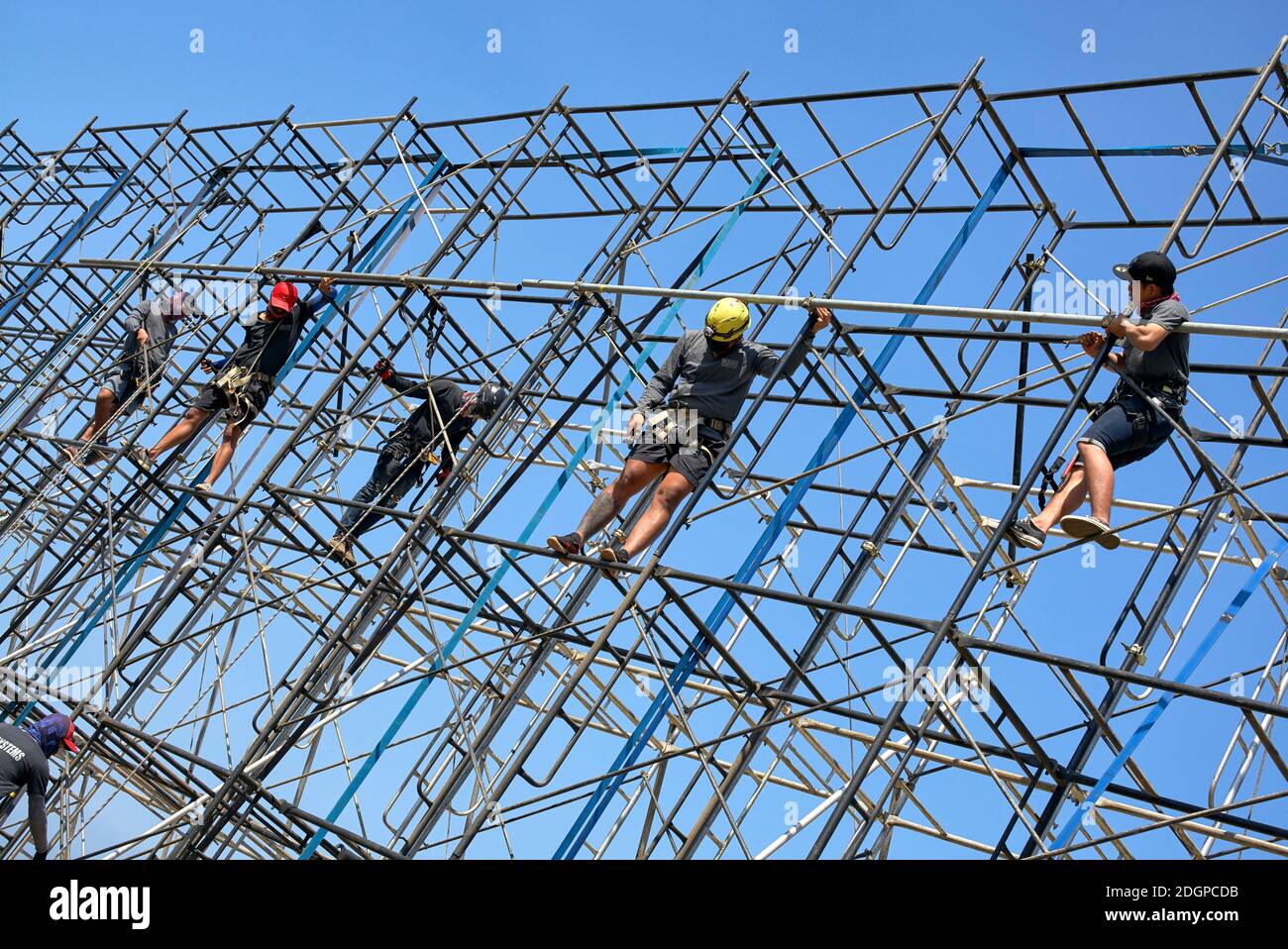 Scaffolders erecting scaffolding in preparation of a stage show ...