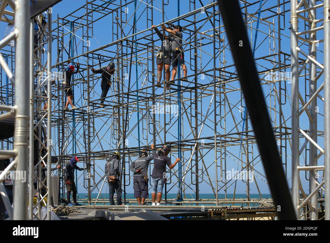 Scaffolders erecting scaffolding in preparation of a stage show ...