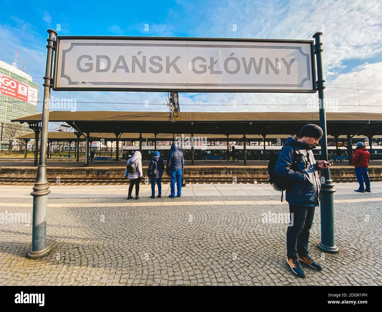 Passengers waiting for a train at the platform of Gdansk Glowny railway ...
