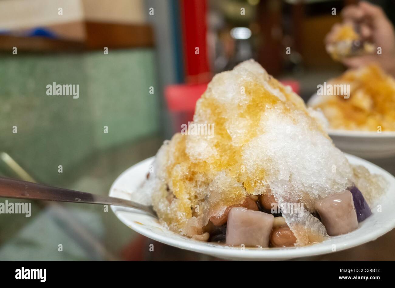Eating shaved ice with colorful dessert Stock Photo - Alamy