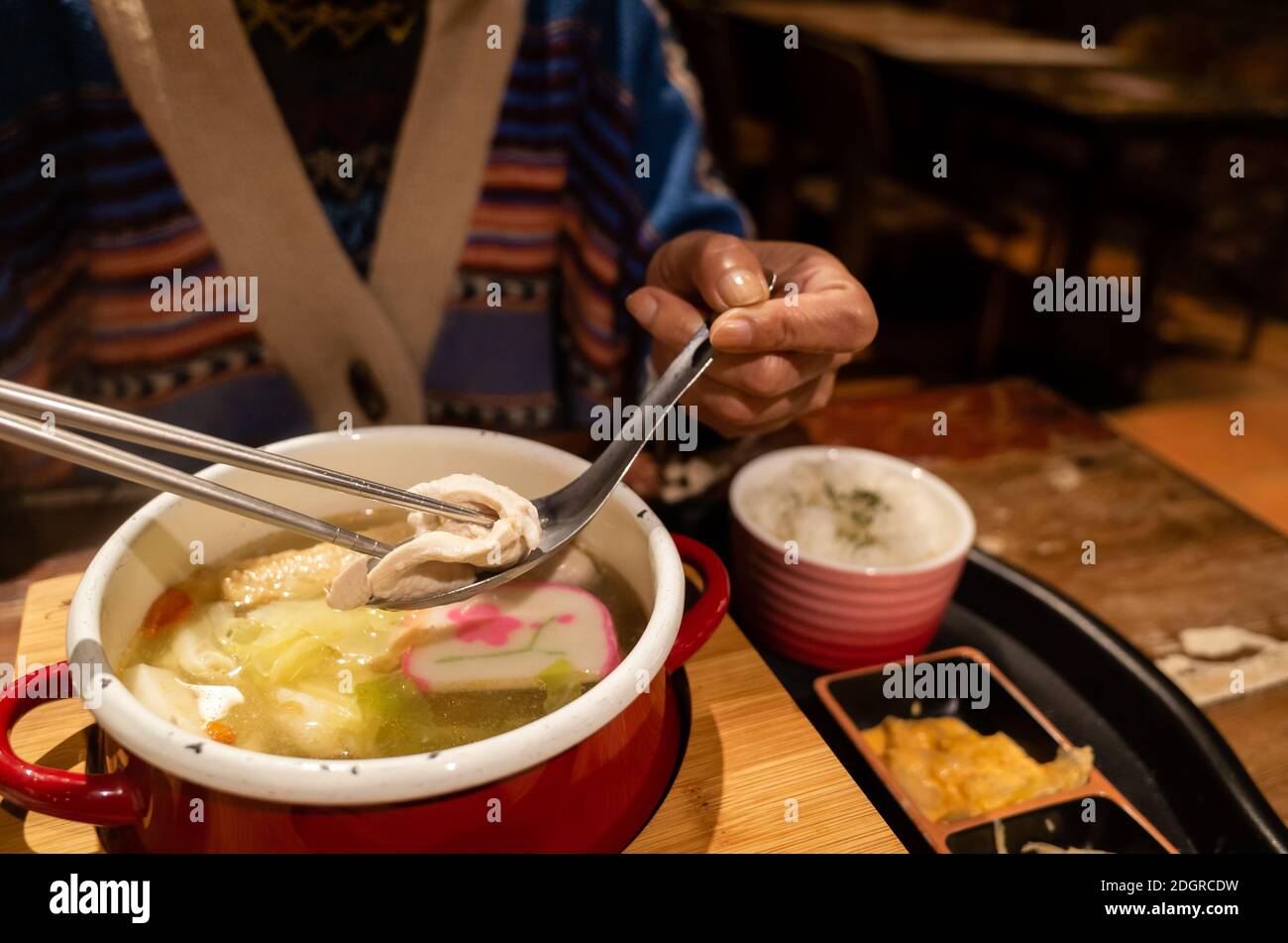 Woman eating hot pot Stock Photo - Alamy