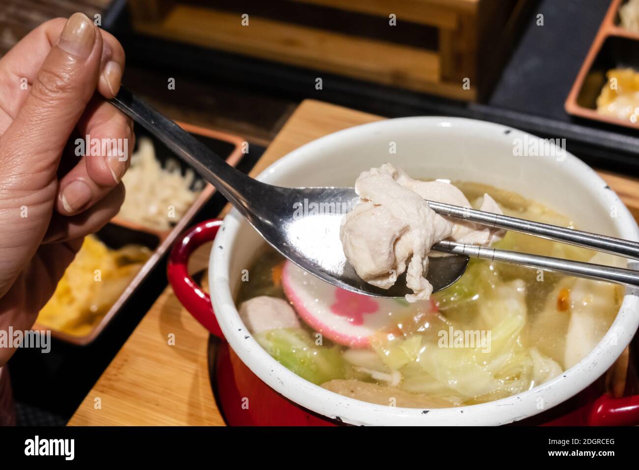 Woman eating hot pot hi-res stock photography and images - Alamy