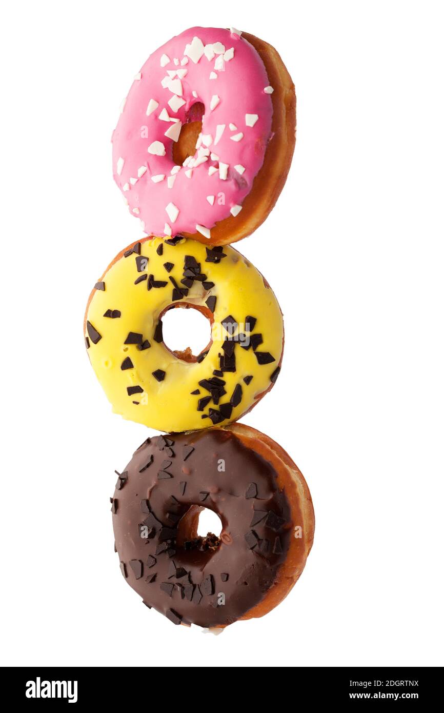 Levitating group of donuts covered with glaze on a white background ...