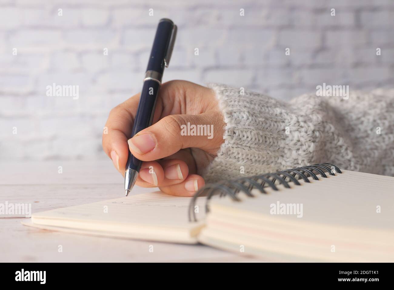 Close up of women hand writing on notepad Stock Photo - Alamy