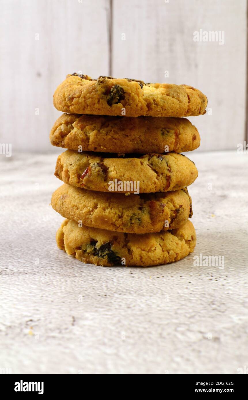 A closeup of freshly baked delicious chocolate chip cookies stacked on ...