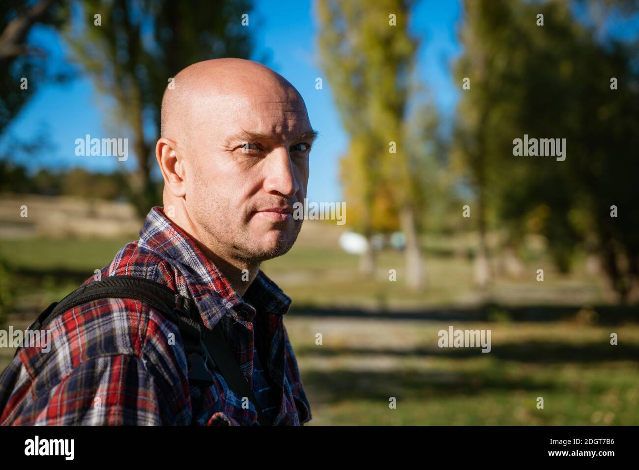 An adult bald man looks into the distance in nature Stock Photo - Alamy