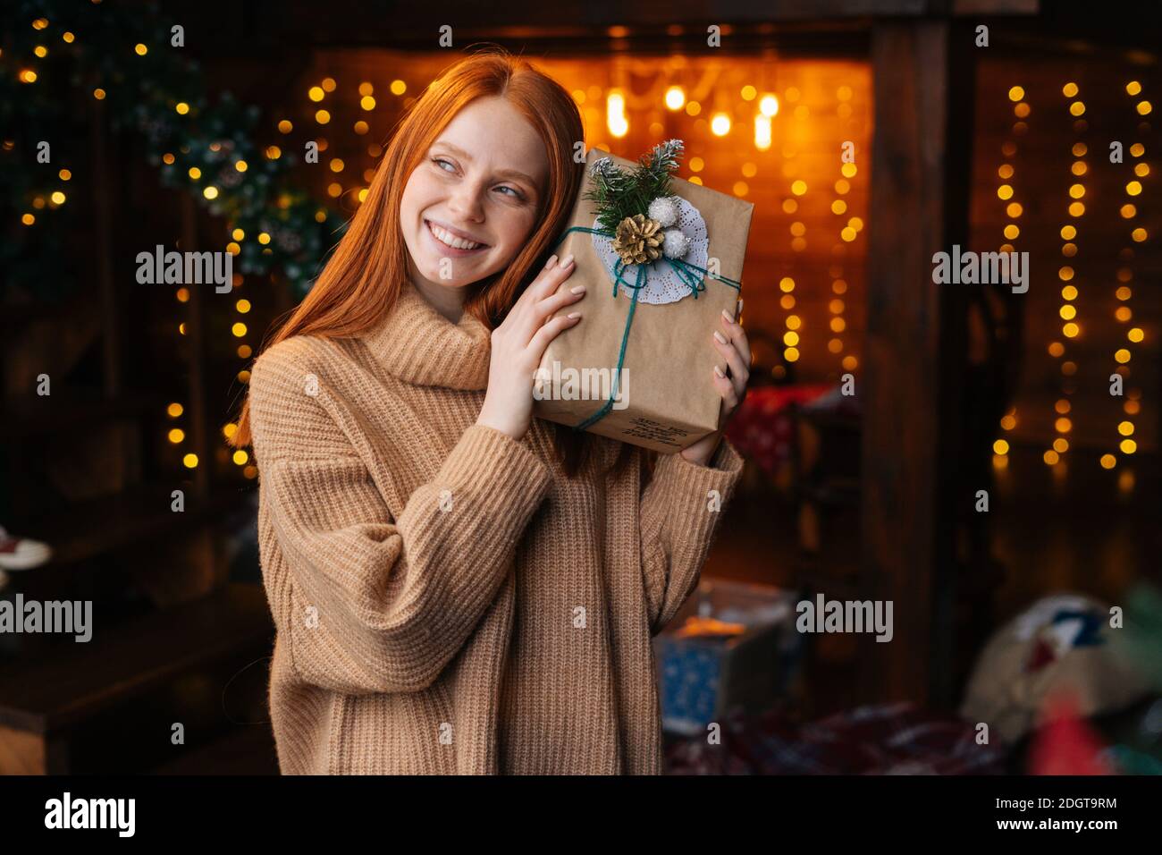 Woman shaking gift box hi-res stock photography and images - Alamy