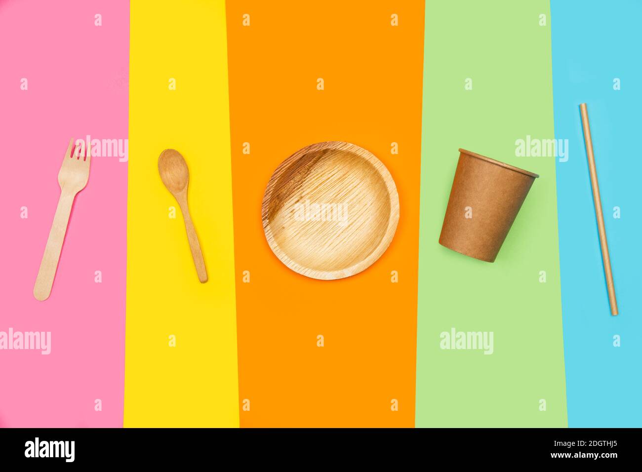 Disposable kitchen utensils on a multicolored background in a top view ...