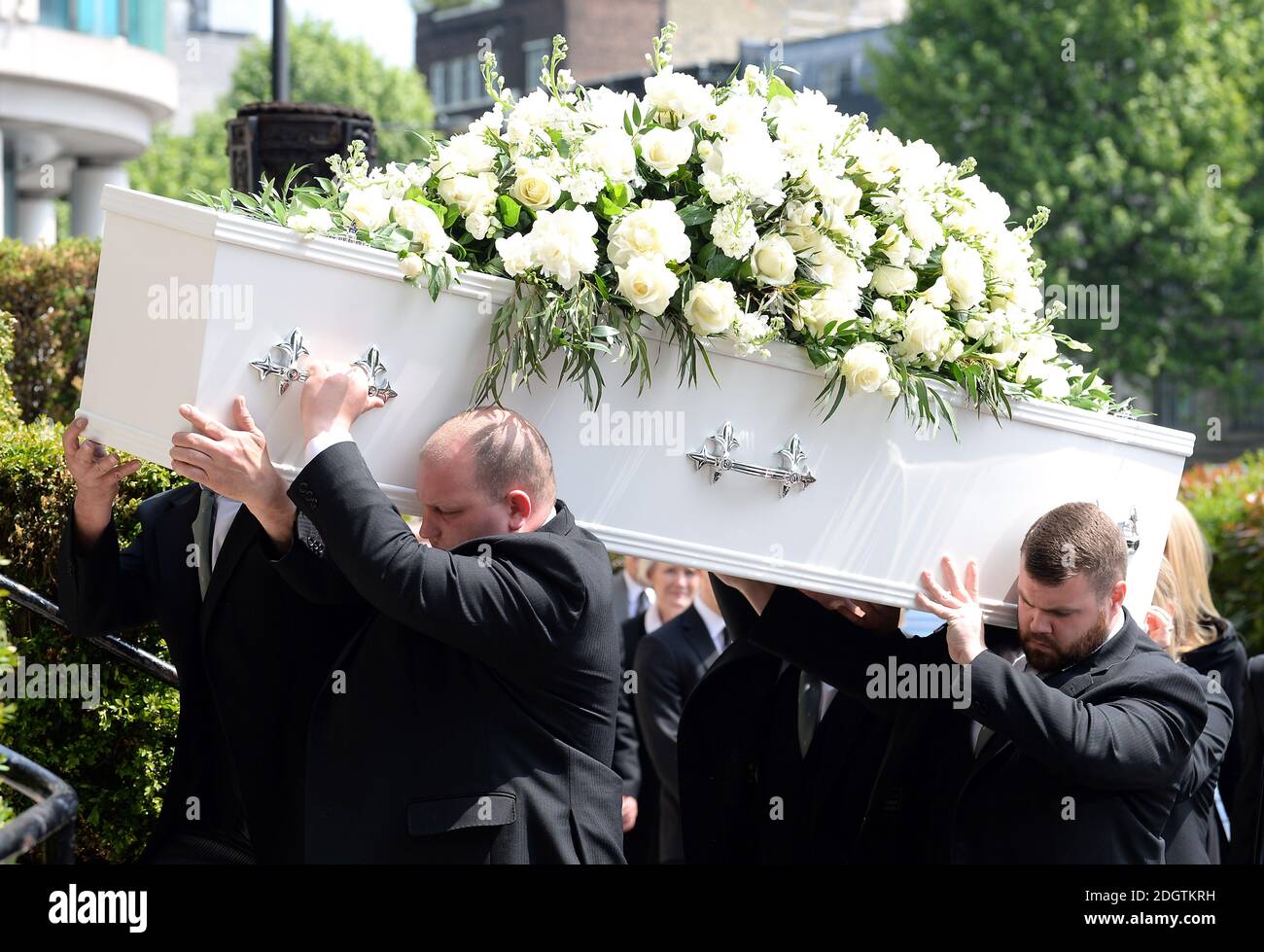 The coffin is carried in to the church during the funeral service of ...