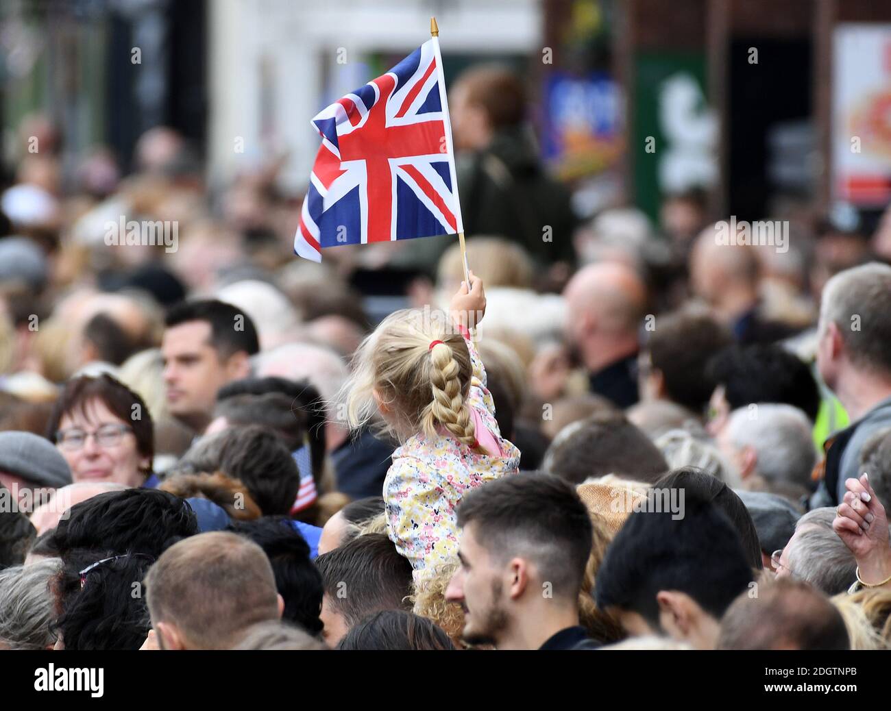 The crowd wait as Queen Elizabeth II and the Duchess of Sussex arrive ...