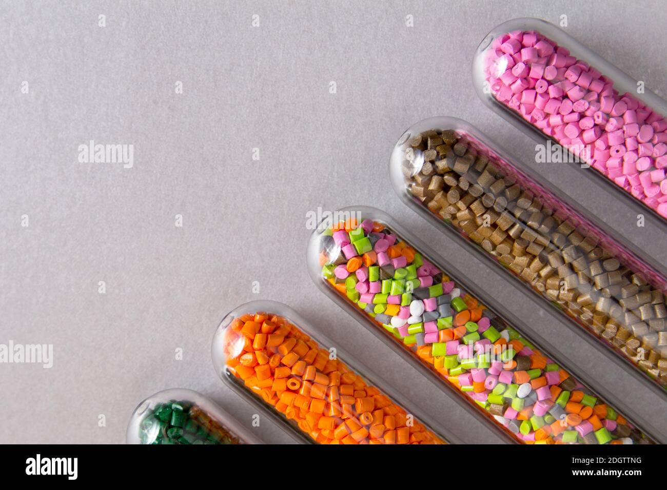Plastic pellets .Polymeric dye in test tubes on gray background Stock ...