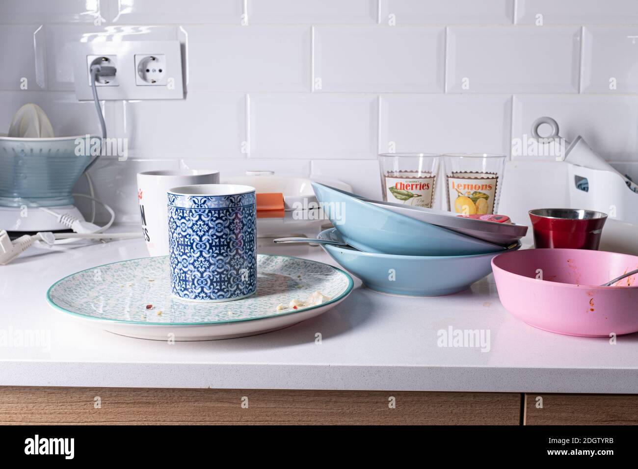 Dirty cutlery, dishes and mugs on a white domestic kitchen Stock Photo ...
