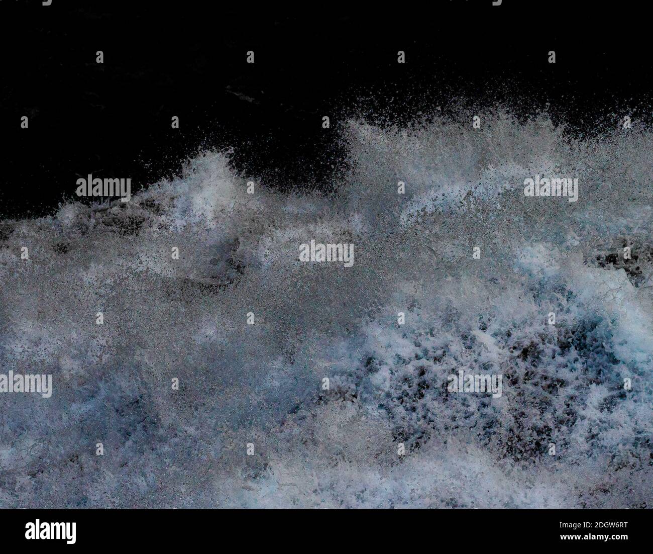 Water from a waterfall splashing down in large volumes with white foam ...