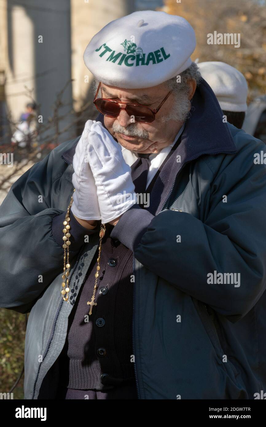 A devout Roman Catholic man prays at the Vatican Pavilion site in ...