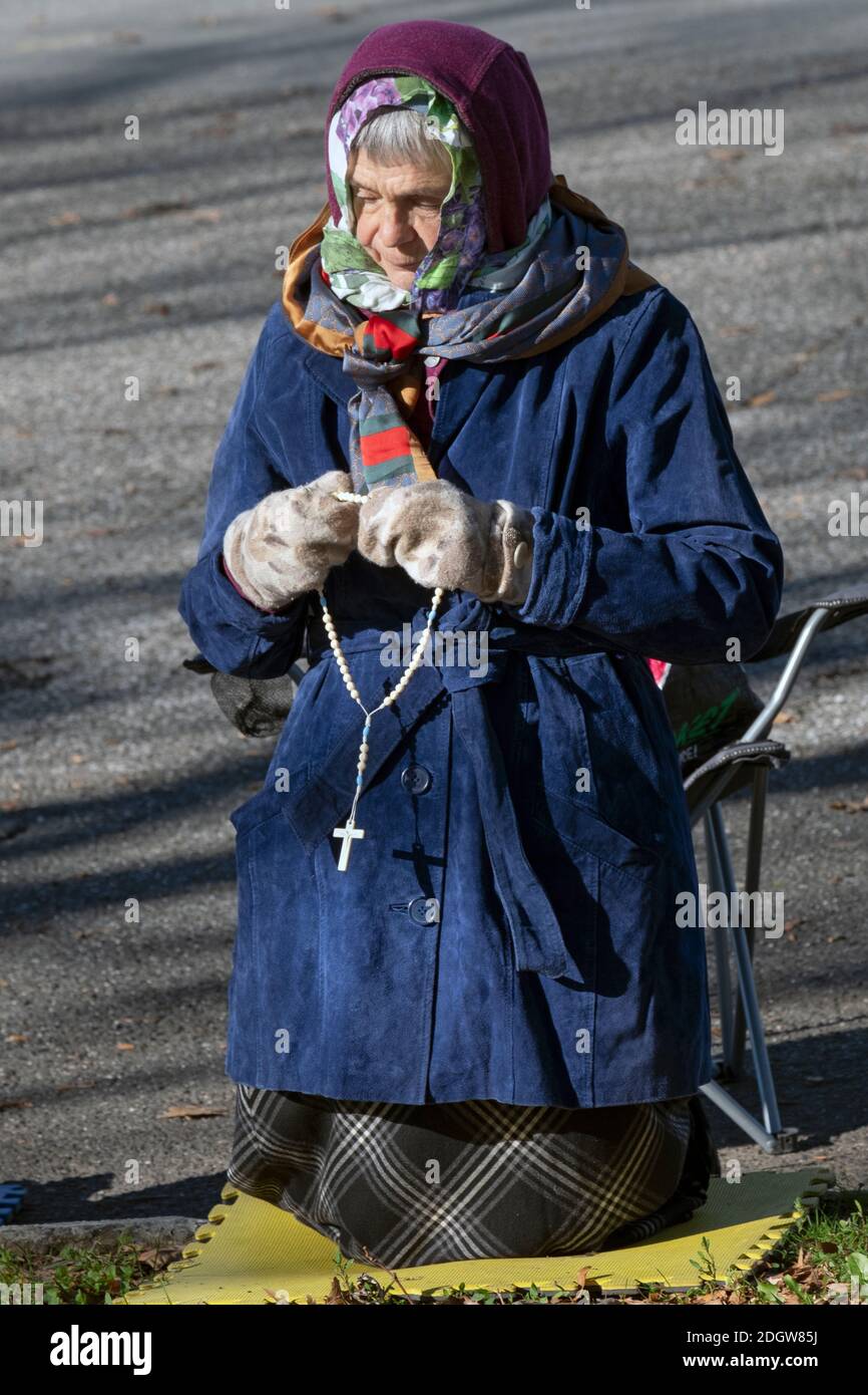 Devout Roman Catholic woman prays at the Vatican Pavilion site in ...