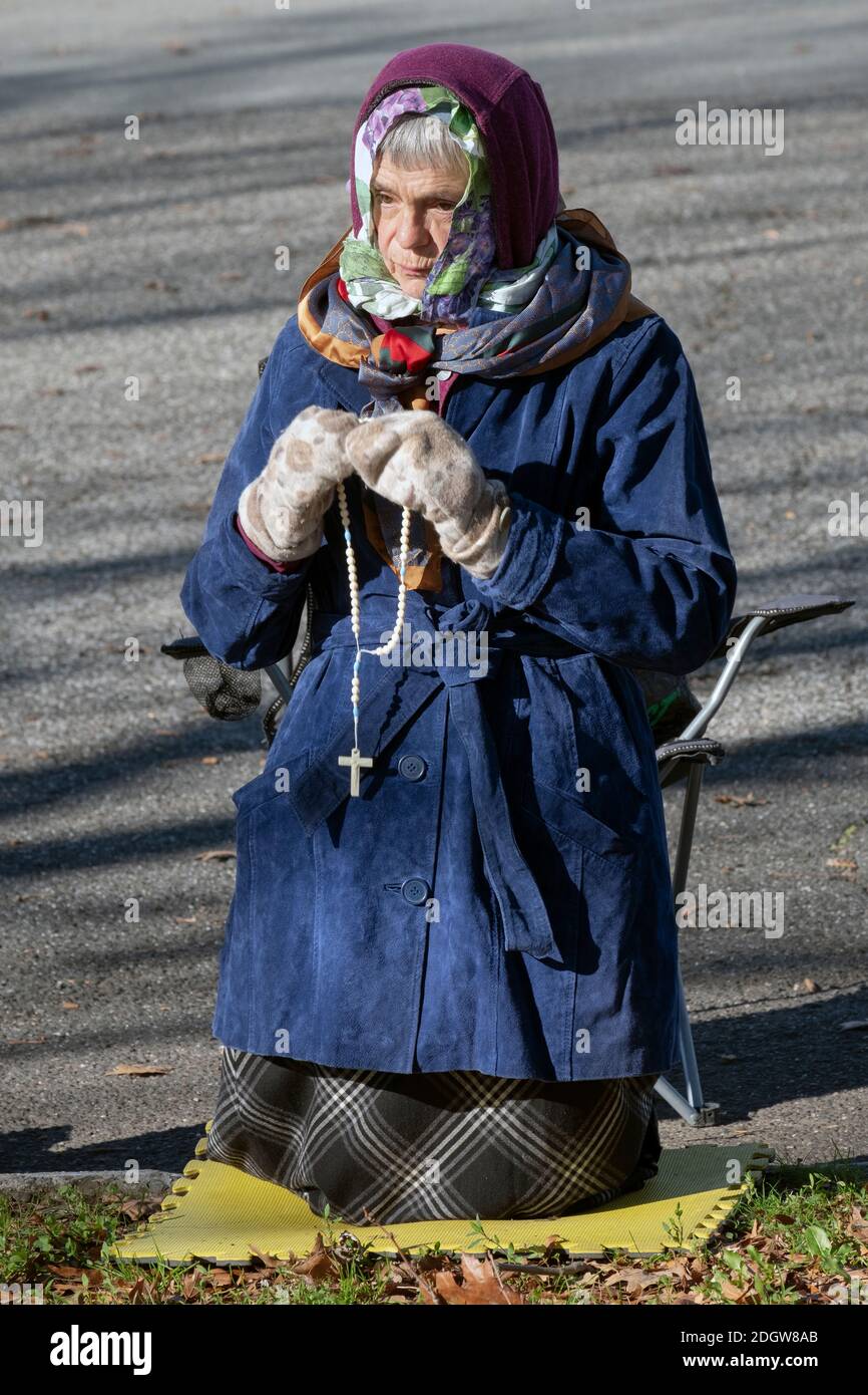 Devout Roman Catholic woman prays at the Vatican Pavilion site in ...