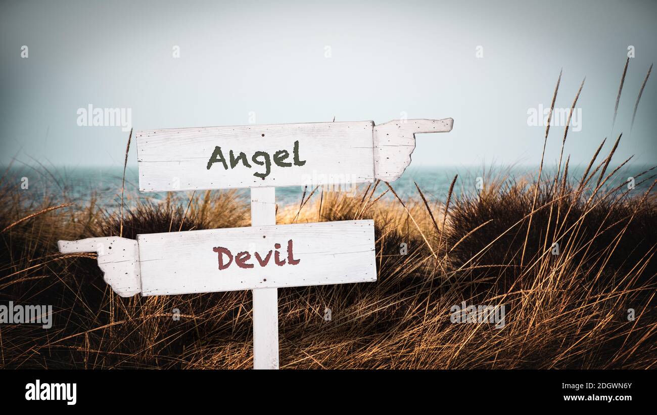 Street Sign to Angel versus Devil Stock Photo - Alamy