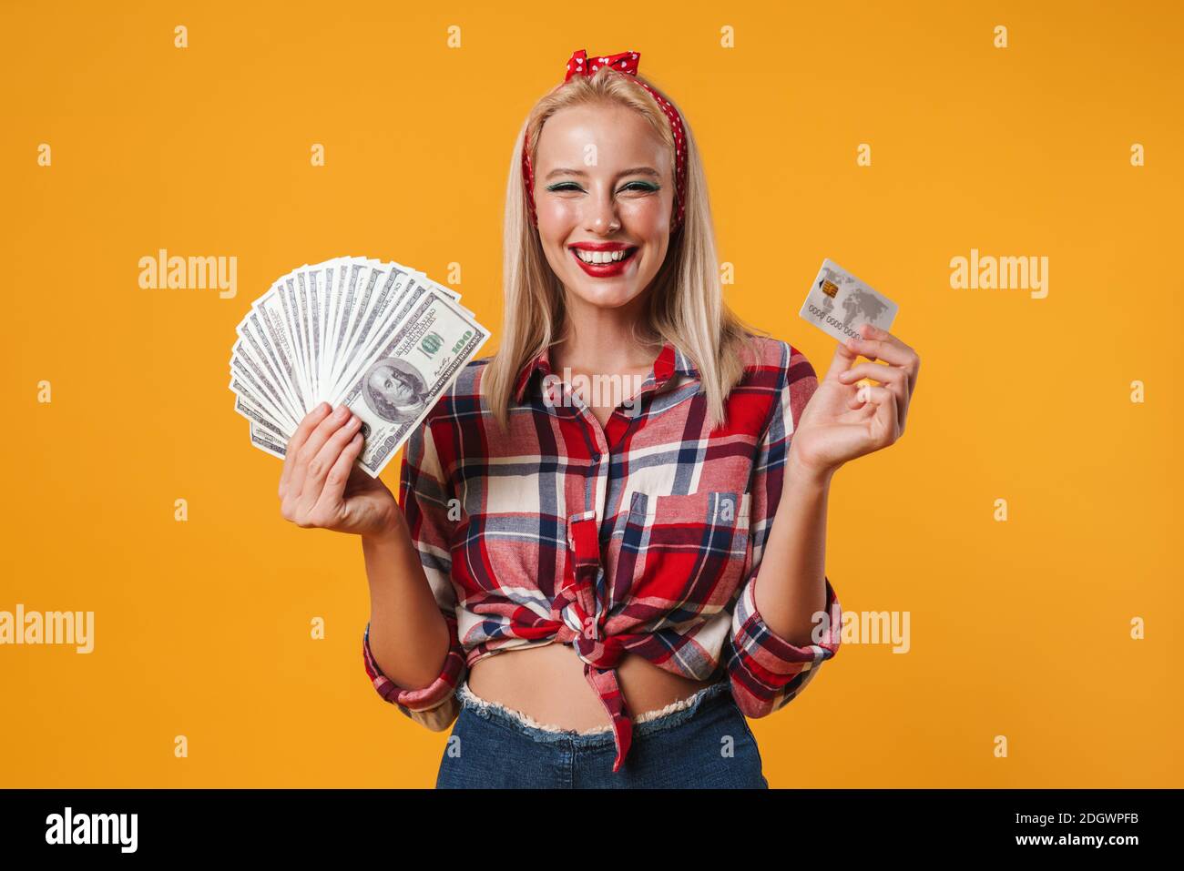 Image of cheerful blonde pinup girl posing with dollars and credit card ...