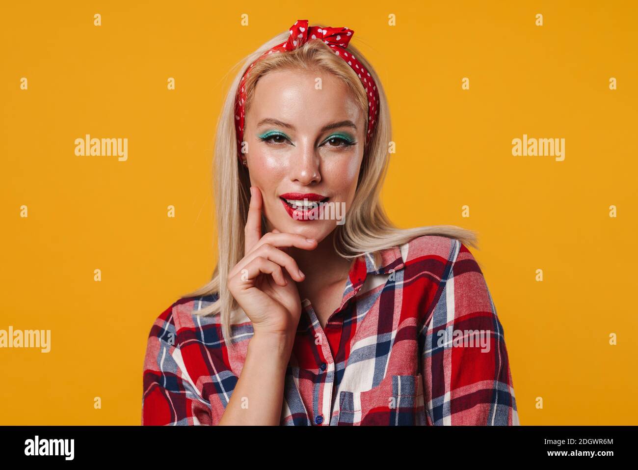 Image of joyful blonde pinup girl smiling and winking at camera ...