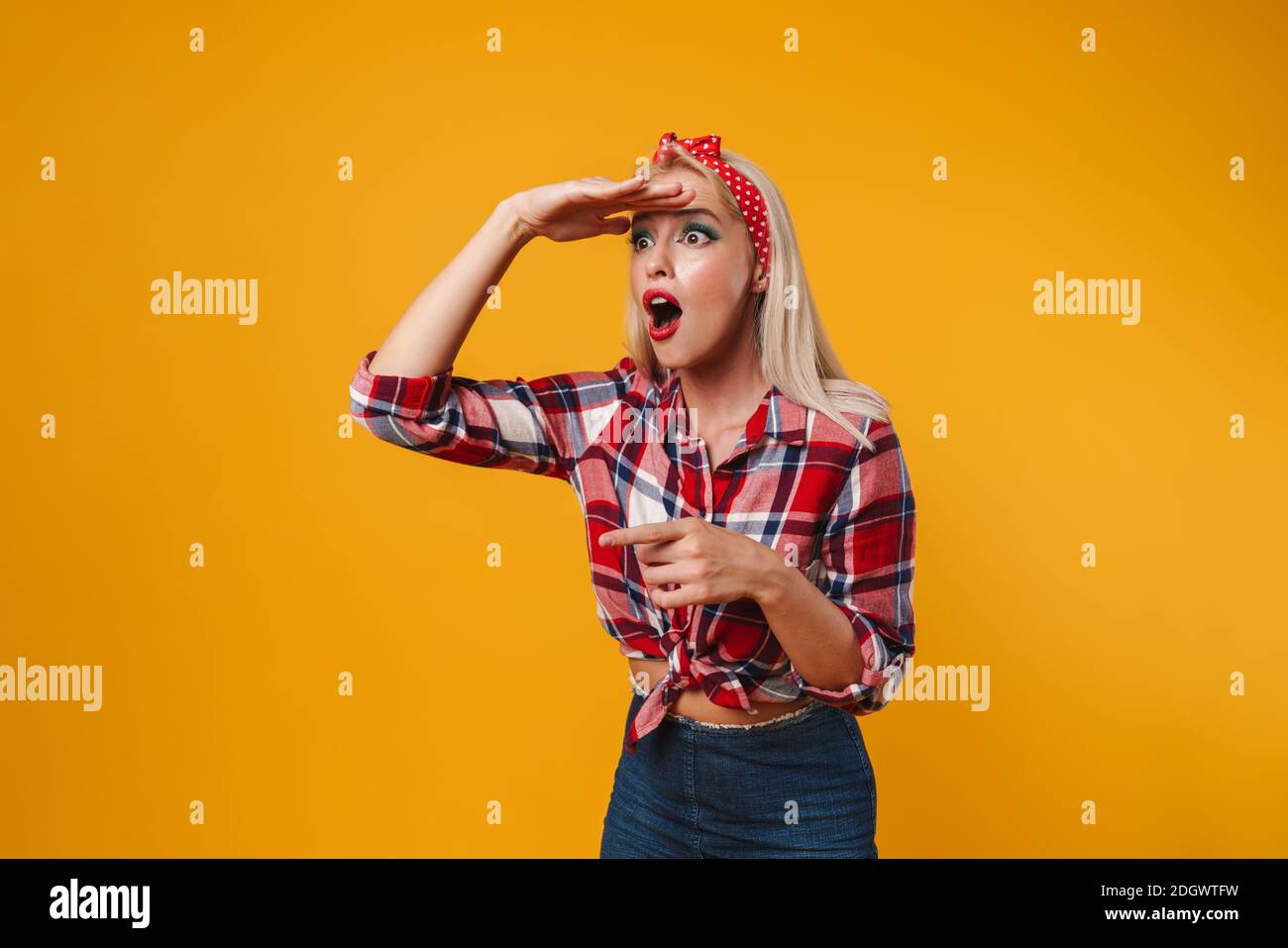 Image of shocked beautiful pinup girl looking and pointing finger aside ...