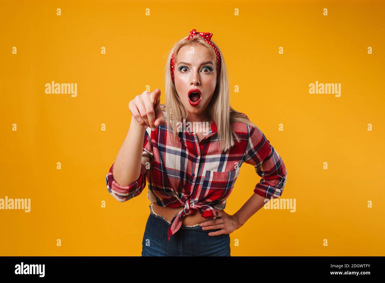 Image of shocked beautiful pinup girl pointing finger at camera ...