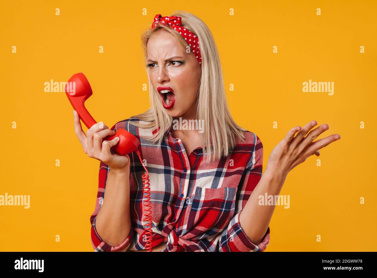 Image of furious pinup girl screaming while posing with handset ...