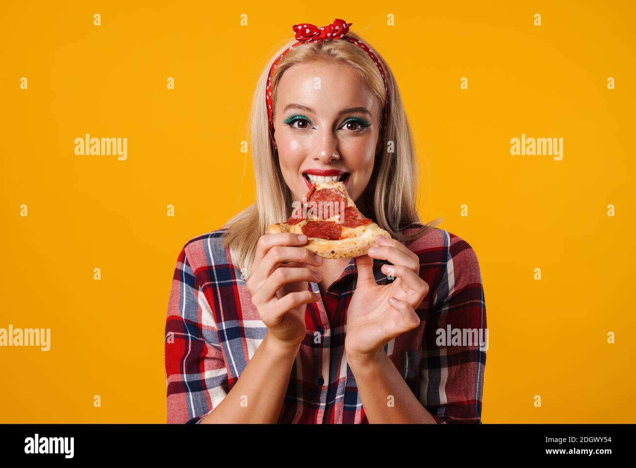 Image of happy charming pinup girl smiling while eating pizza isolated ...