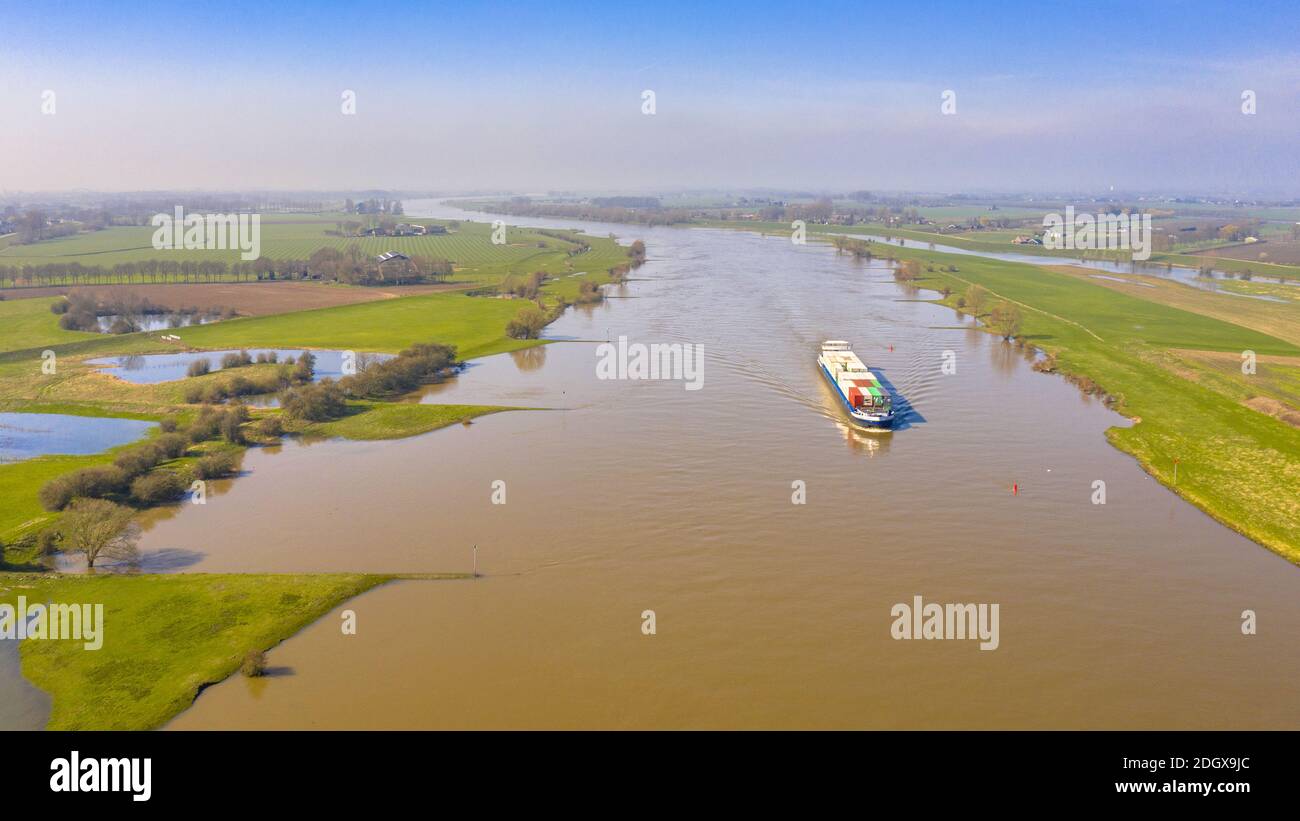 Inland container ship on River Lek aerial view near the village of ...