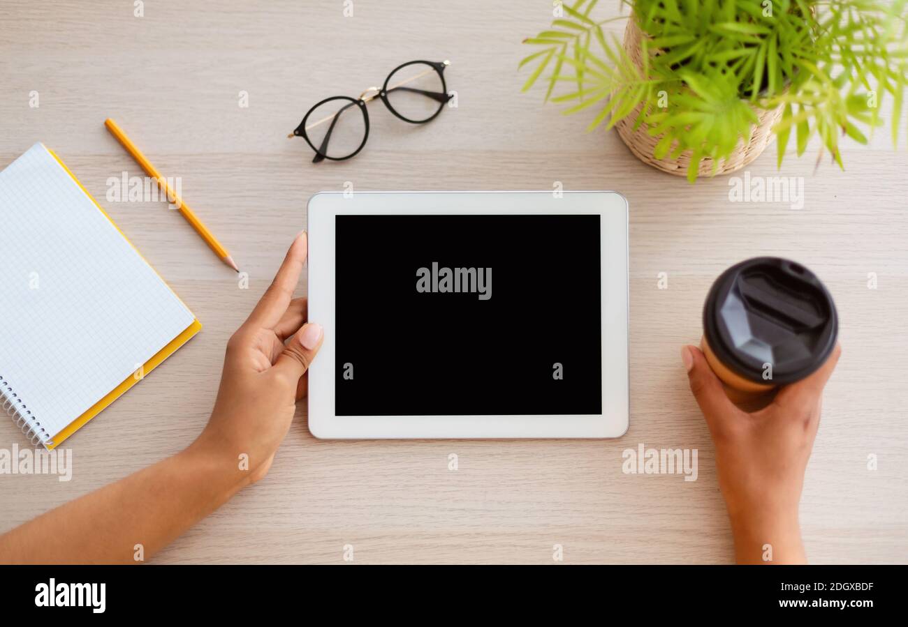 Above view black woman using personal tablet at home Stock Photo - Alamy