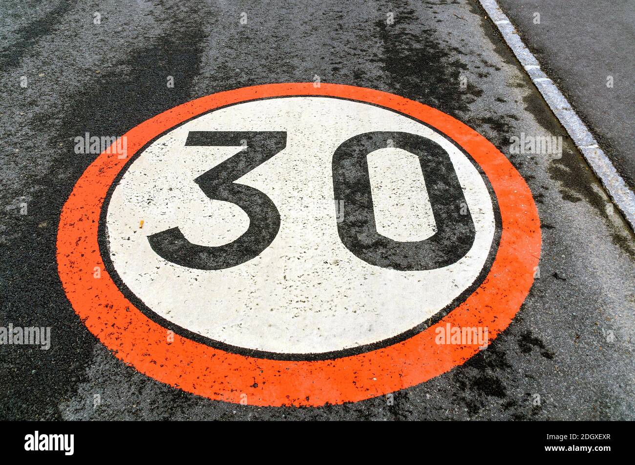 traffic sign of a speed limit of 30 km/h, painted on an asphalted ...