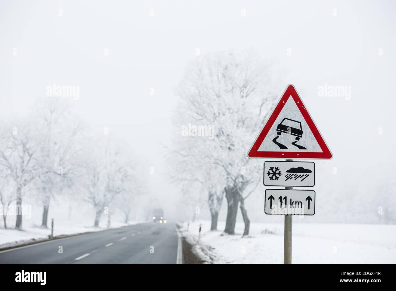 winter warning sign with snow Stock Photo - Alamy