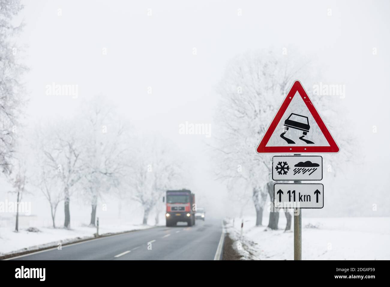 winter warning sign with snow Stock Photo - Alamy