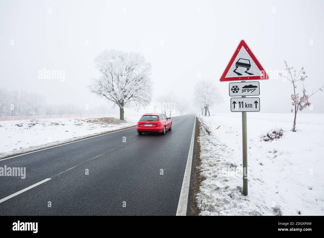 winter warning sign with snow Stock Photo - Alamy