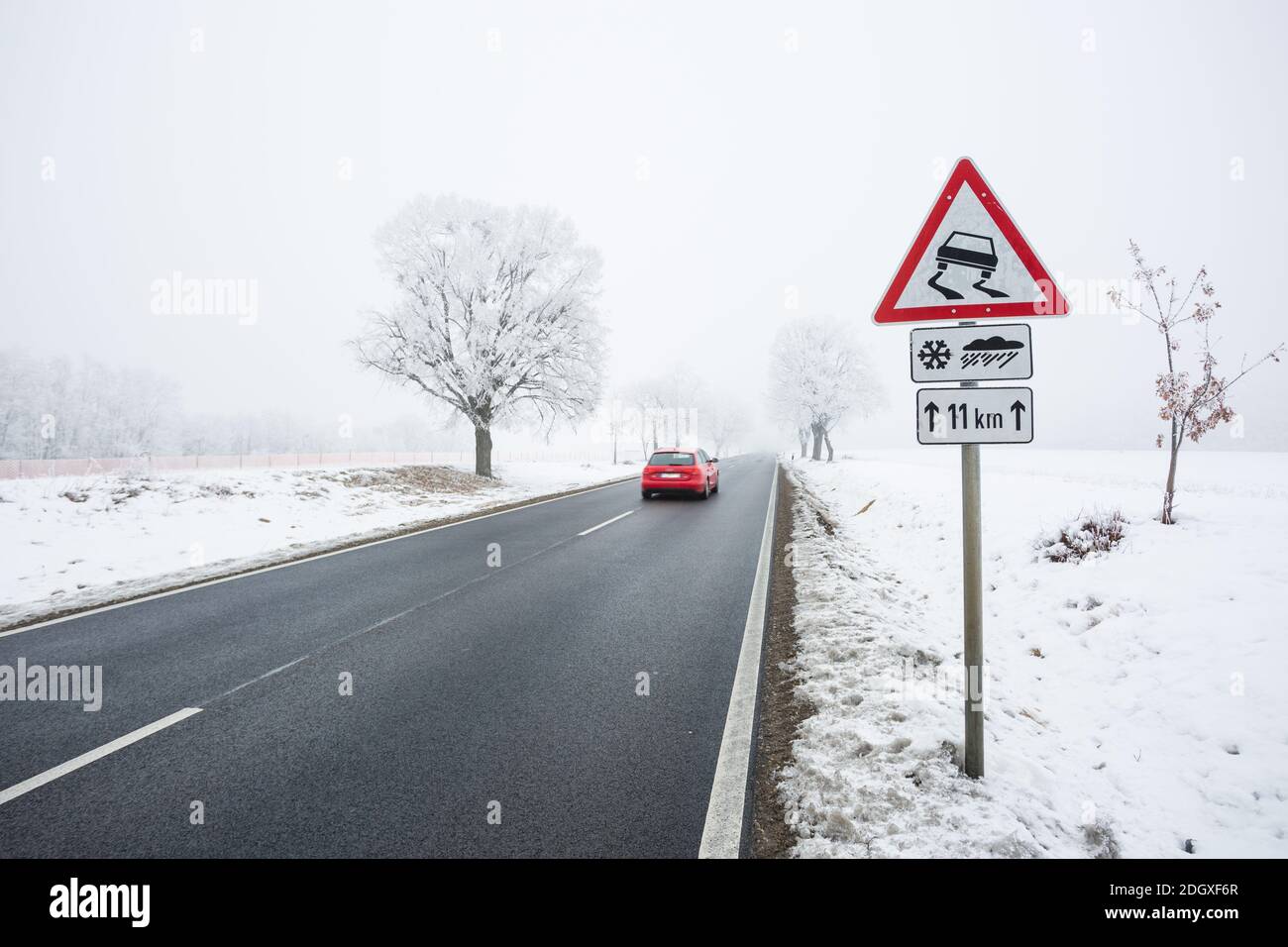 winter warning sign with snow Stock Photo - Alamy