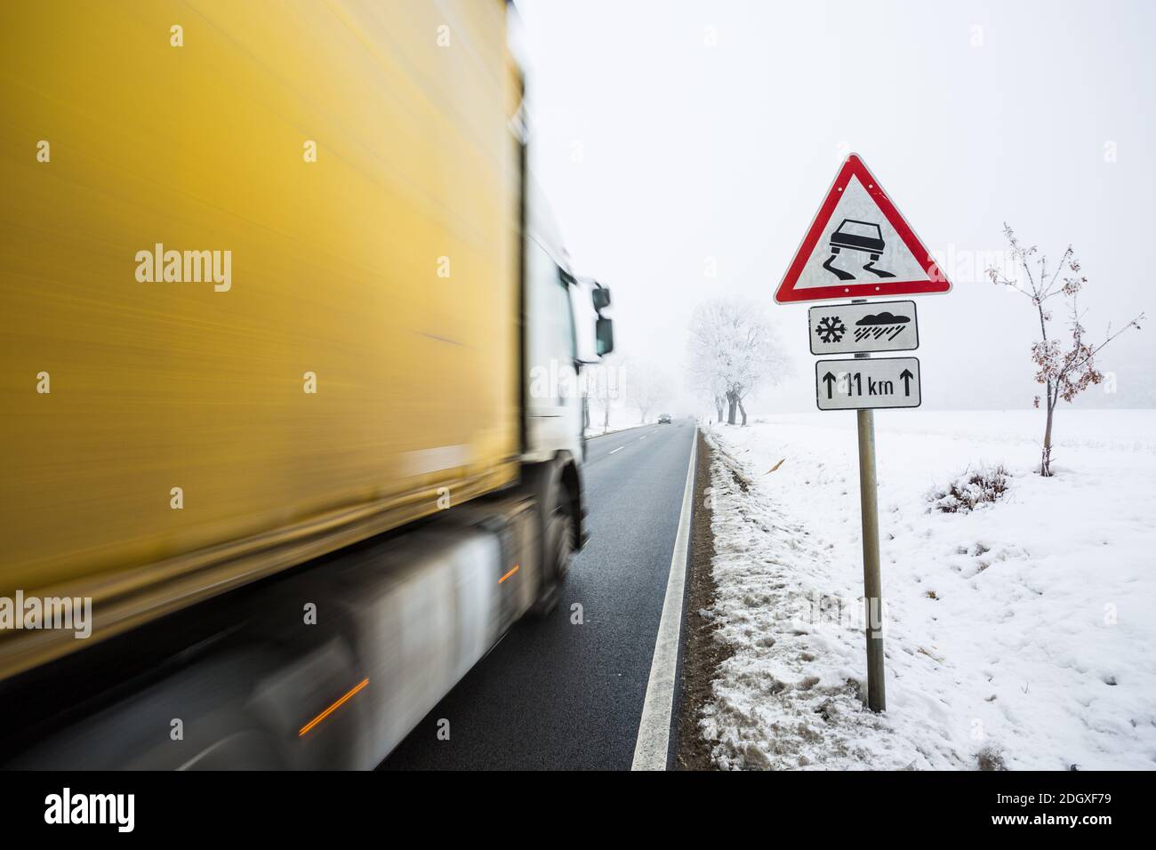 winter warning sign with snow Stock Photo - Alamy