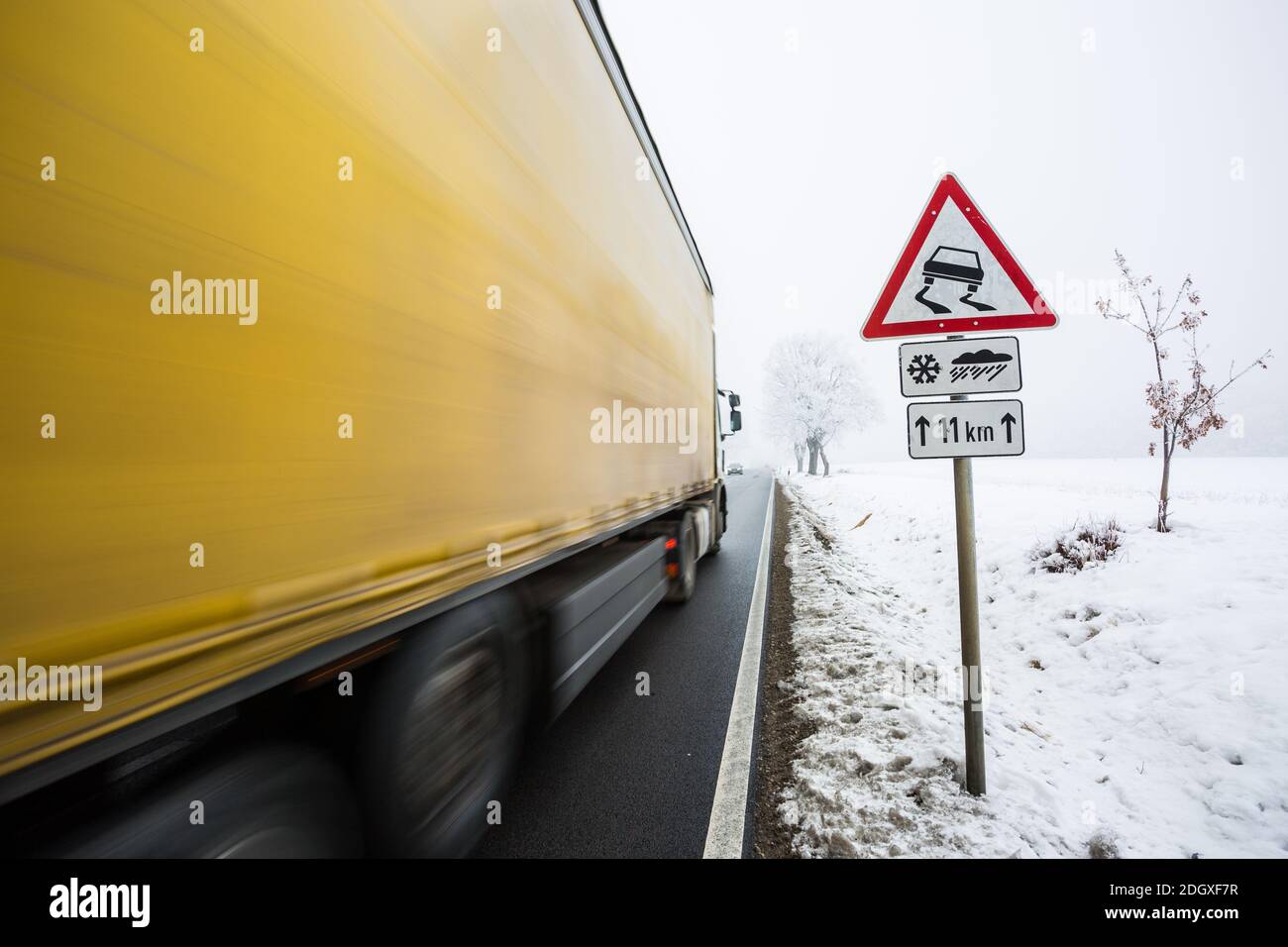 winter warning sign with snow Stock Photo - Alamy