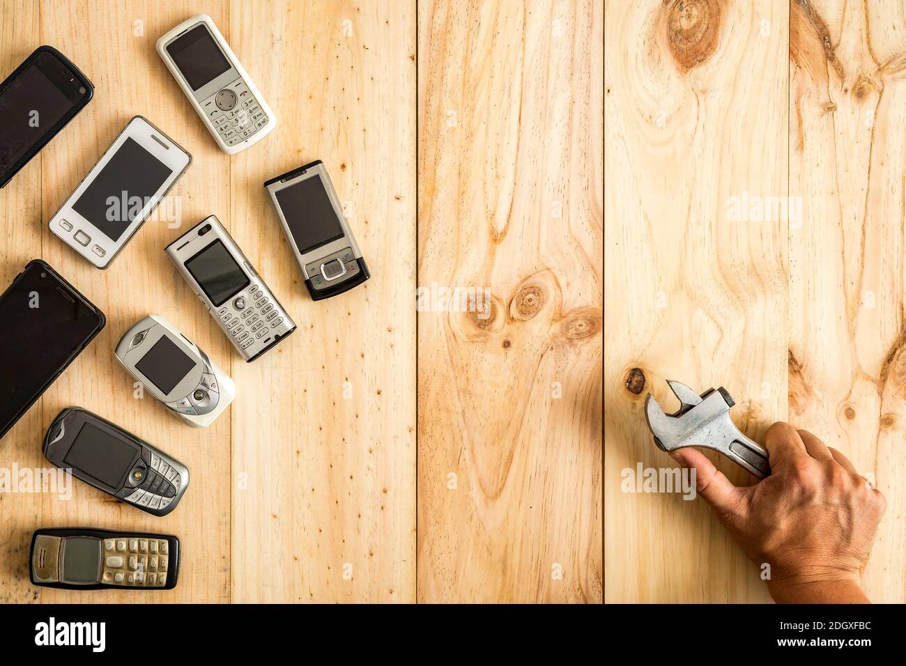 Several old and new mobile phones with expert human hand ready to ...