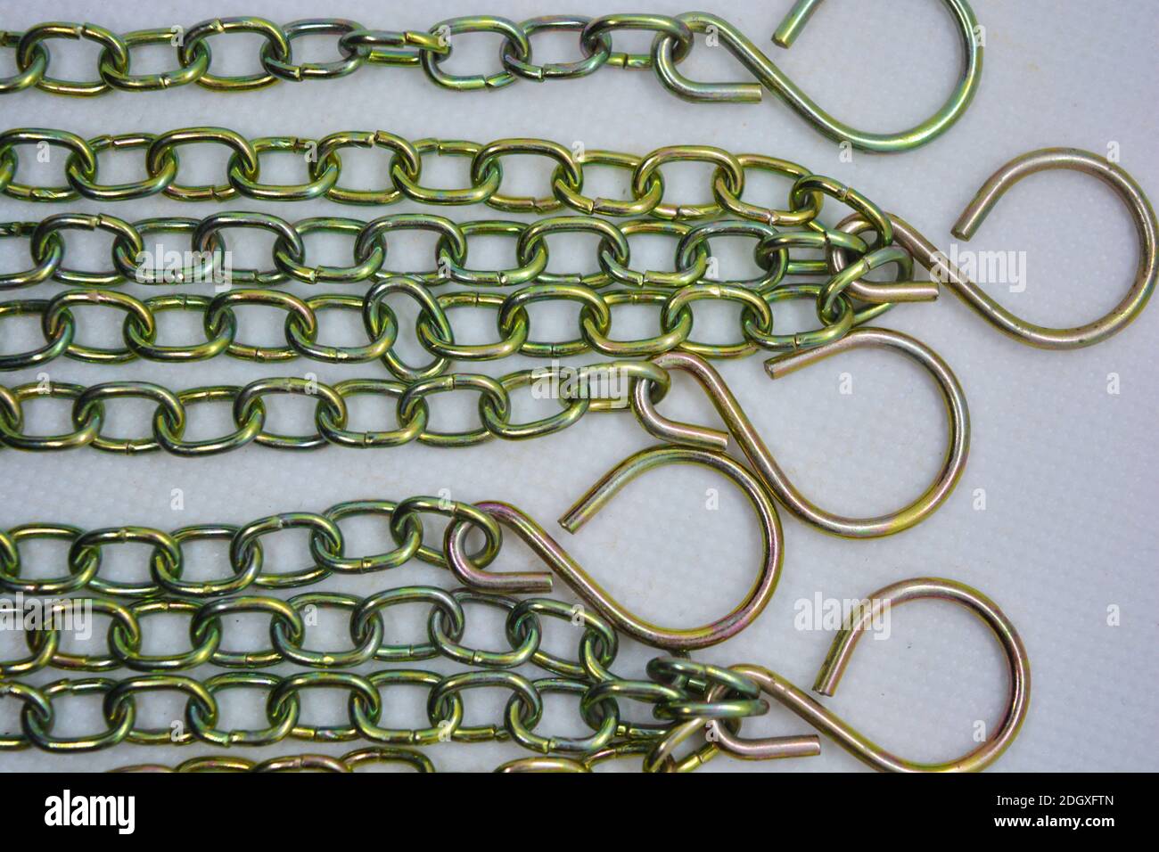 Metal chains, overflow chains and large hooks are arranged randomly on ...