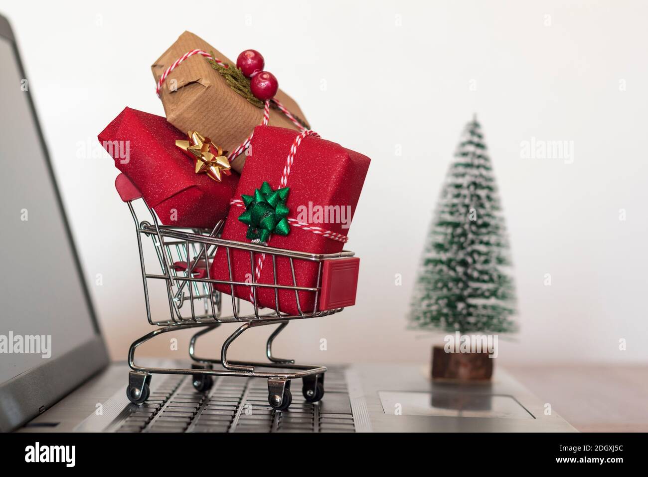 Shopping cart with christmas gifts on laptop computer. Online shopping ...