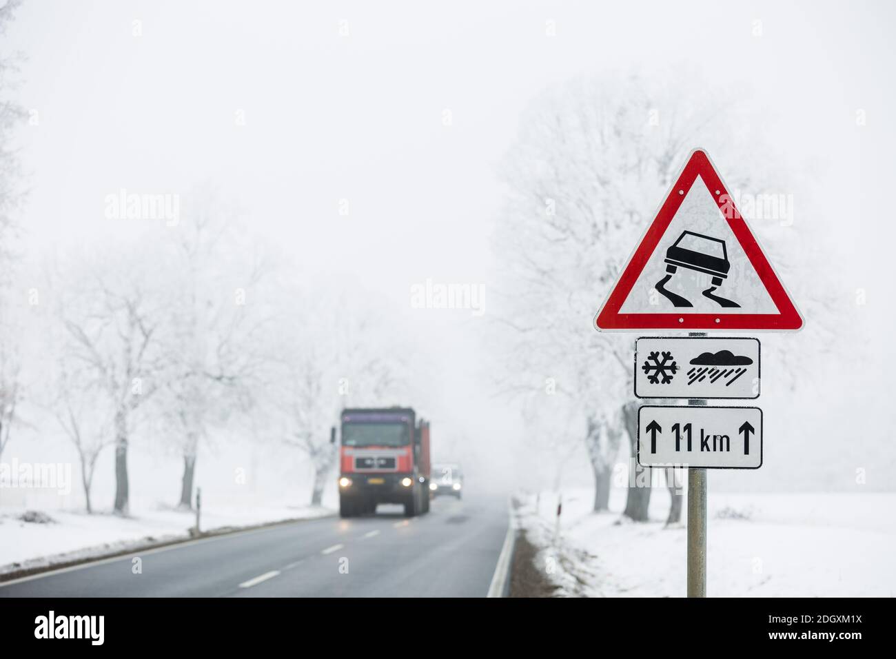 winter warning sign with snow Stock Photo - Alamy