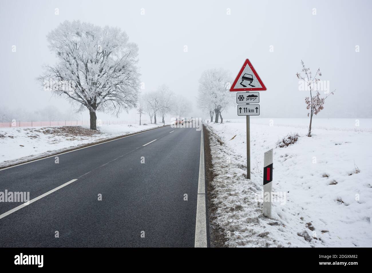 winter warning sign with snow Stock Photo - Alamy