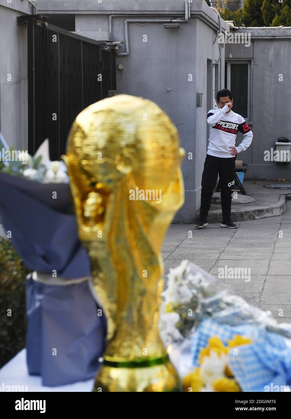 A football fan weeps in front of the memorial stall for late Argentine ...