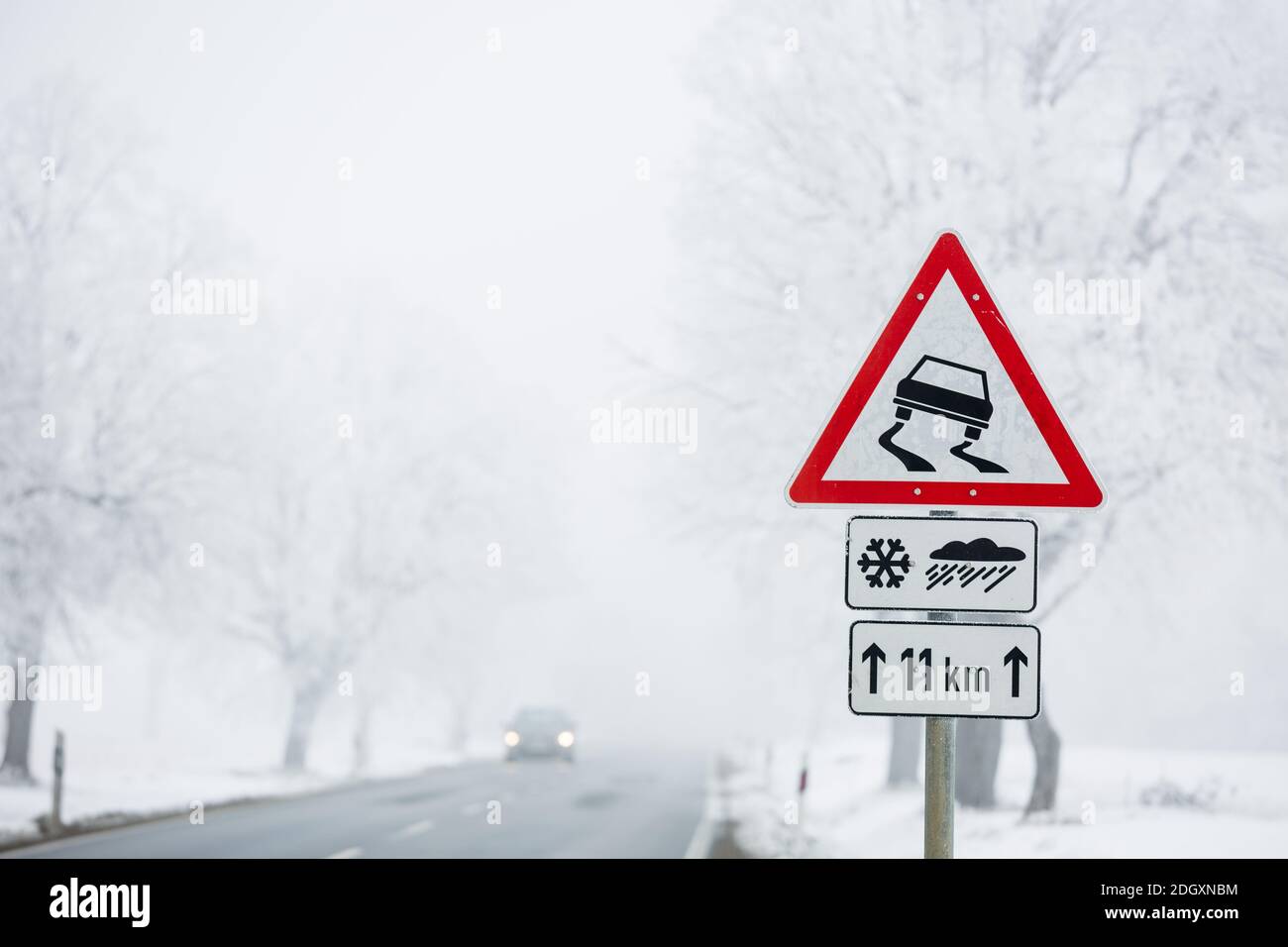 winter warning sign with snow Stock Photo - Alamy