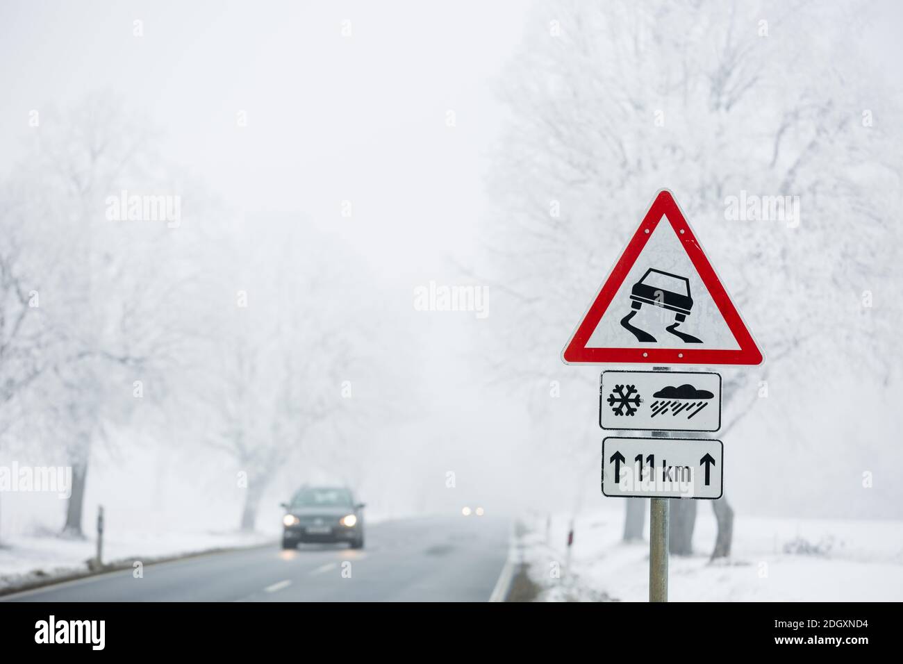 winter warning sign with snow Stock Photo - Alamy