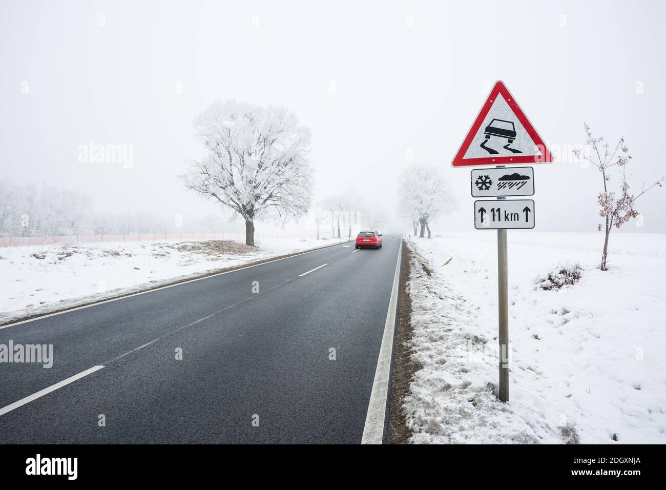 winter warning sign with snow Stock Photo - Alamy