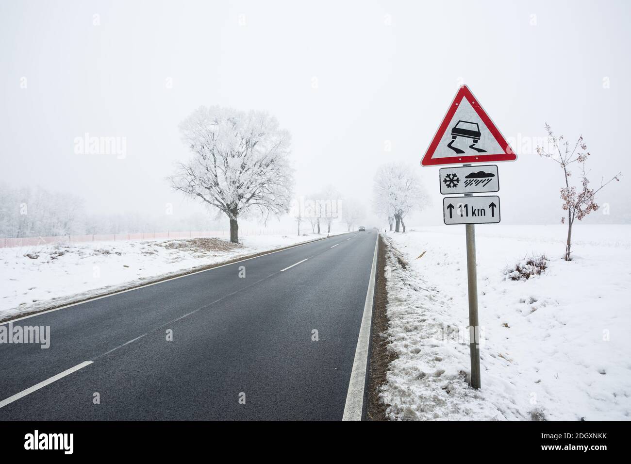 winter warning sign with snow Stock Photo - Alamy