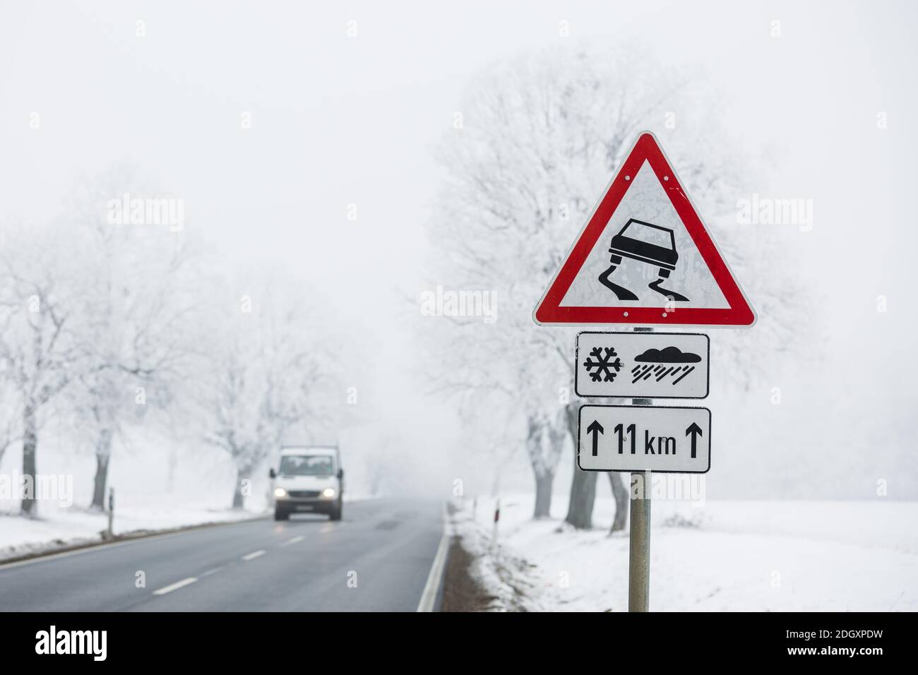 winter warning sign with snow Stock Photo - Alamy
