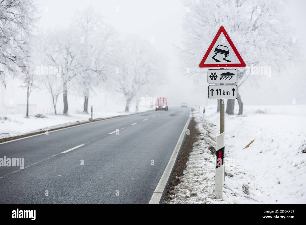winter warning sign with snow Stock Photo - Alamy