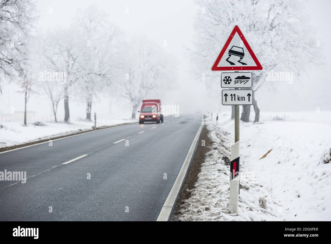 winter warning sign with snow Stock Photo - Alamy